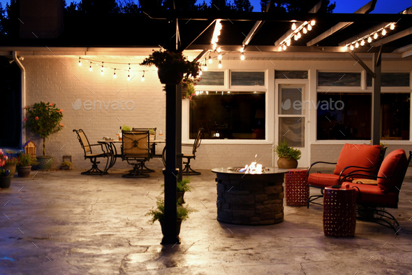 Comfortable outside seating area with fire pit table, dining table and ...