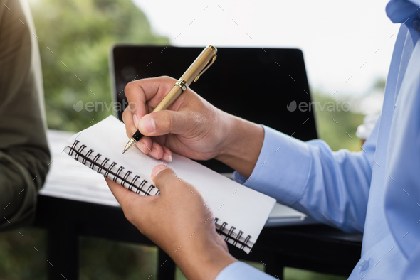 Male hands taking notes on a handwritten notepad, creative writing ...