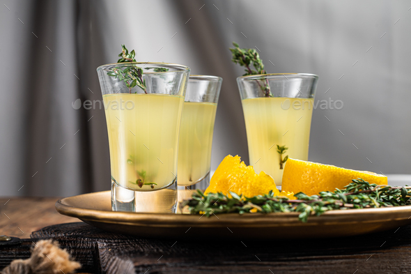 Limoncello shots, Italian lemon liqueur. Wooden background. Top view ...
