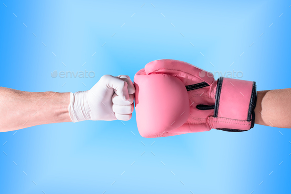 Fist of a nurse/doctor against a boxing glove Stock Photo by ...