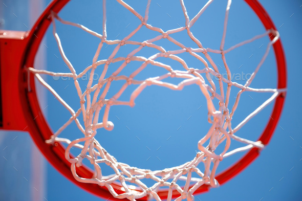 Basketball hoop, red ring and net, blue sky background, underview Stock ...