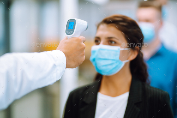 Office staff undergo temperature screening at the entrance. Business ...