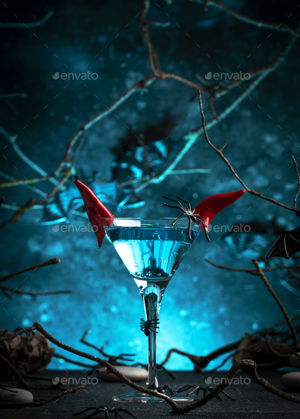 Halloween alcoholic cocktail evil martini on scary dark blue background ...