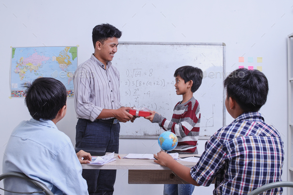 Teachers day, student presenting gift to teacher Stock Photo by ...