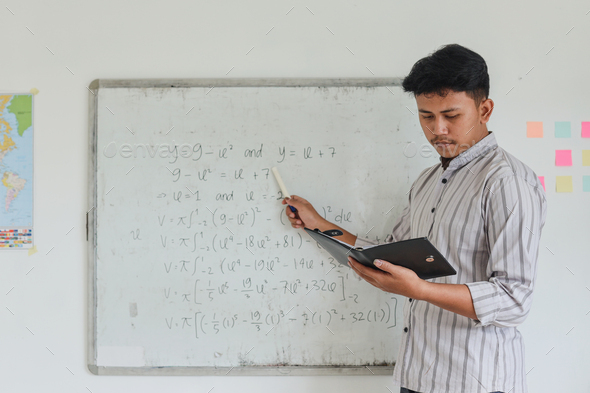 Male teacher teaching at classroom Stock Photo by Queenmoonlite | PhotoDune