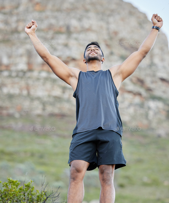 Shot of a handsome young man standing alone outside and feeling ...