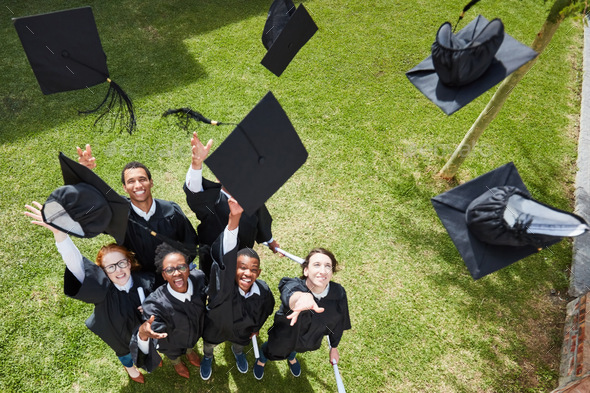 Green Graduation Caps In The Air
