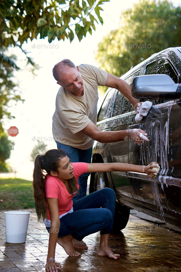 Shot of a father and daughter washing a car together outside Stock ...