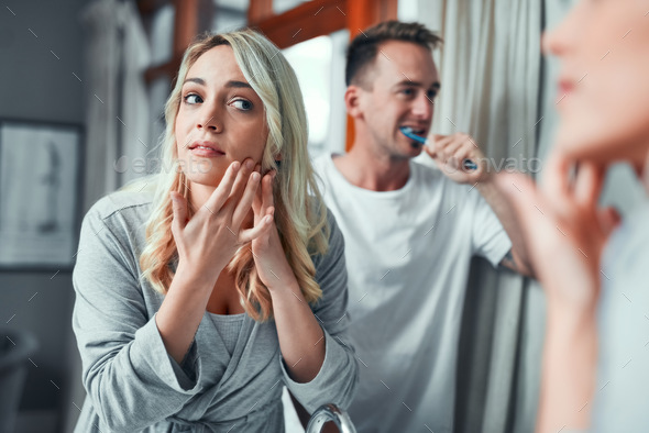 Shot of a young couple getting ready together in the bathroom at home ...