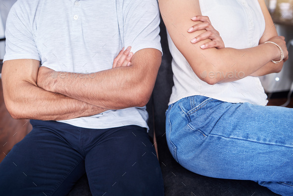 Shot of an unrecognizable couple sitting with their arms crossed during ...