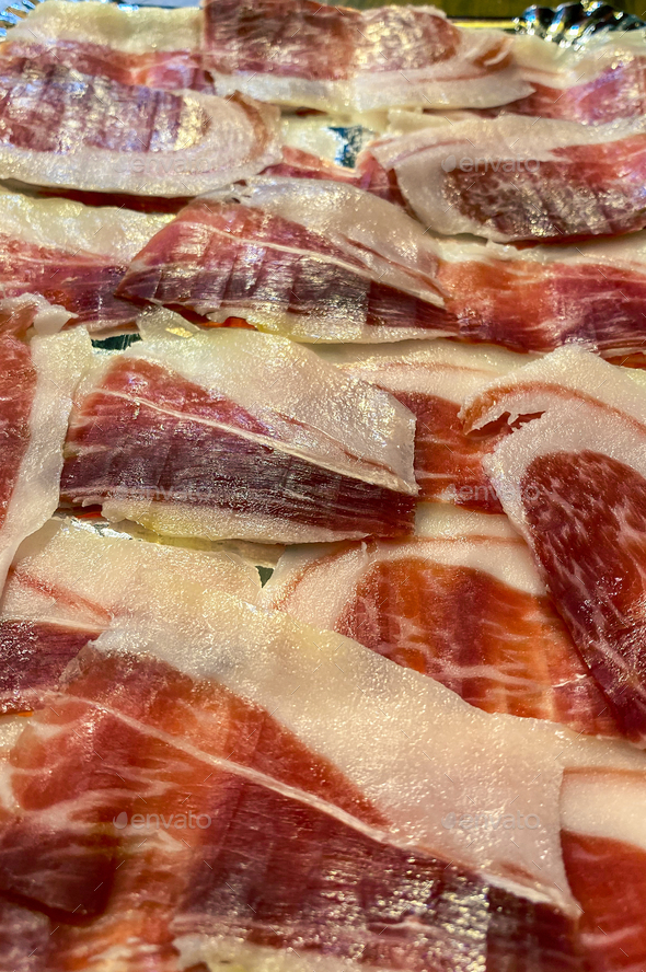 Slices spanish dried pork also known as Jamon Serrano. Typical tapa ...