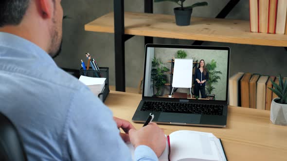 Man Student Study Online By Conference Video Call Laptop Writes in ...