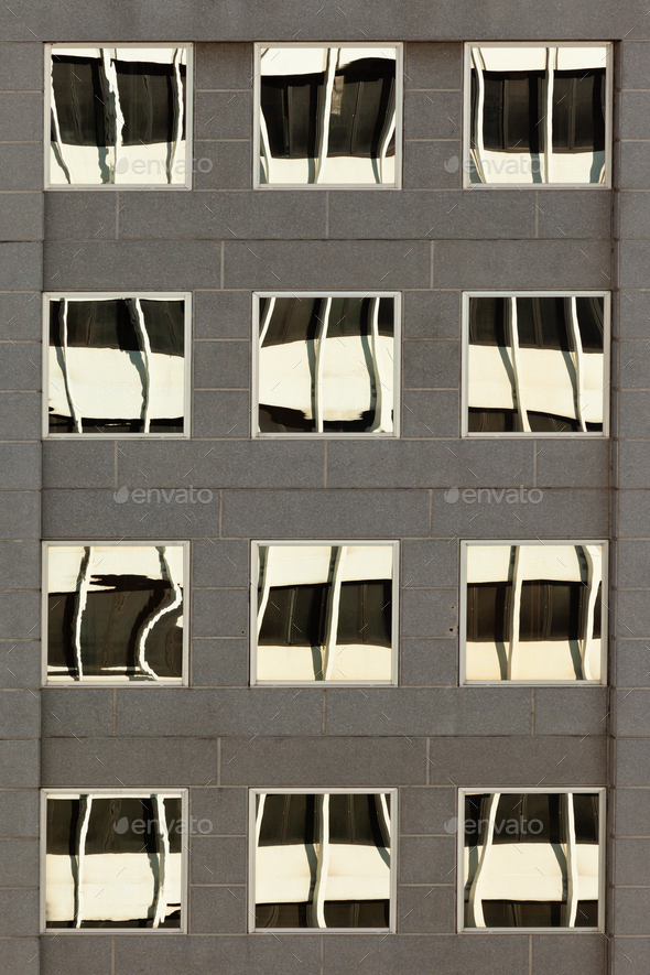 Facade with reflections of building on windows Stock Photo by pilens