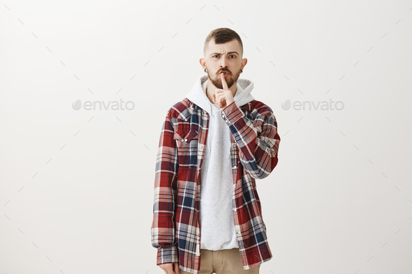 Shut up. Strict bothered attractive guy with beard and stylish haircut ...
