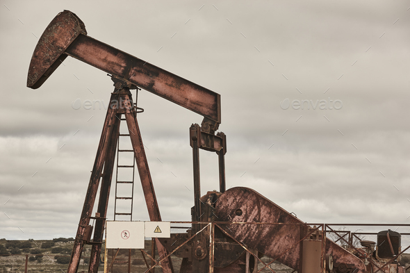 Rusty oil pumping machine. Pump jack. Petroleum extraction. Global ...