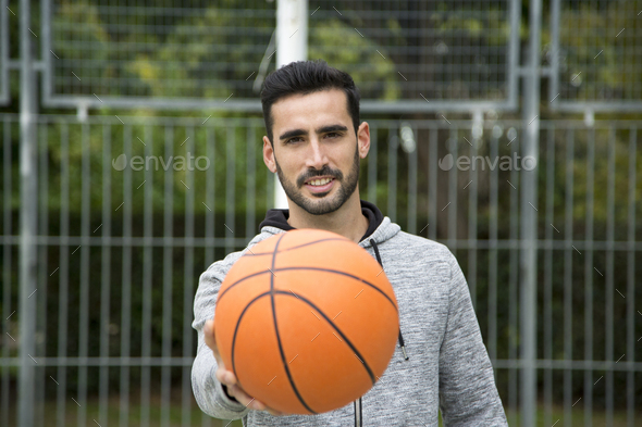 Focus on the smiley face of a man with a basketball ball Stock Photo by ...