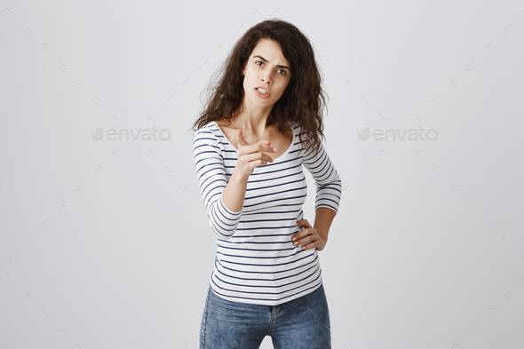 Girl warns not to play with her temper. Angry fed up woman with curly ...