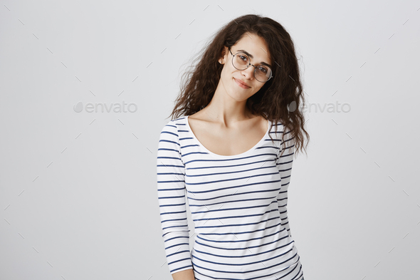 Ready to teach you lesson. Charming smart curly-haired female with ...