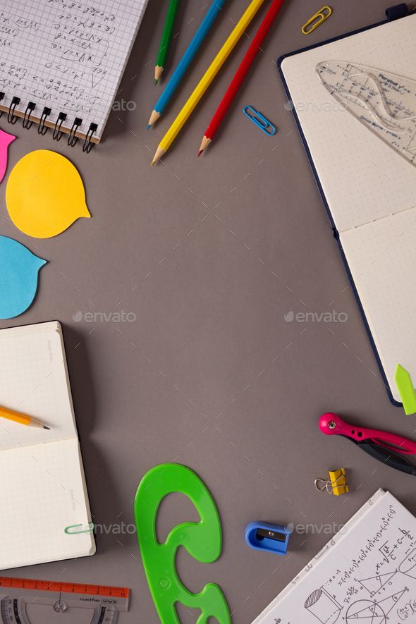 Open notepad and school stationary supplies at paper table background ...