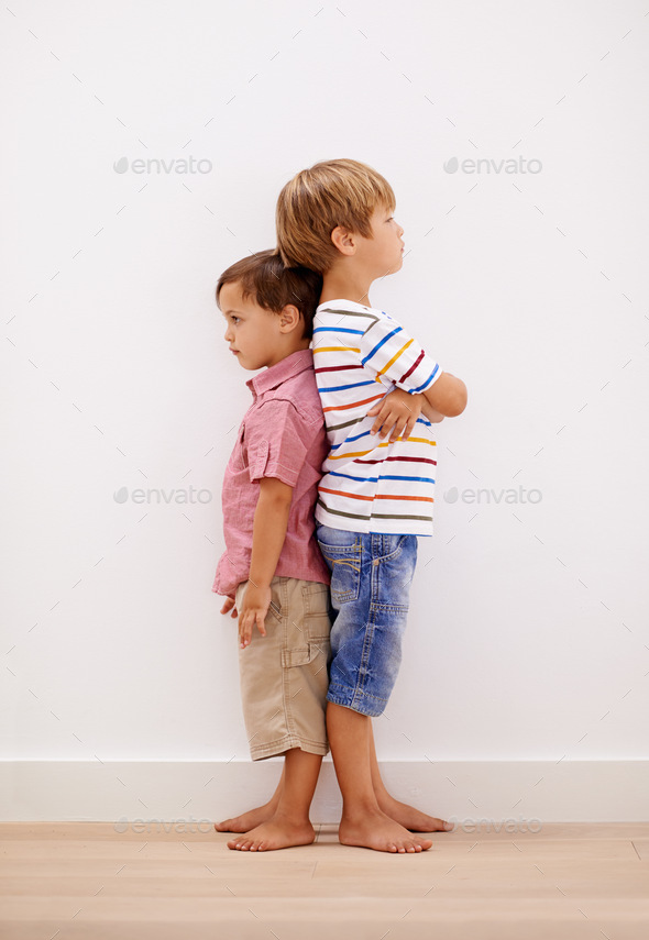 Hes taller than me. Two little boys standing back to back. Stock Photo ...