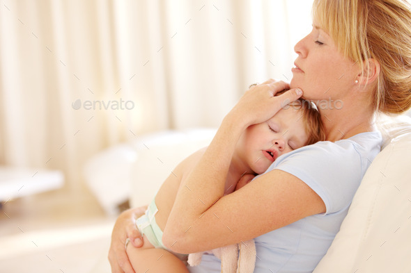 Beautiful bonding. Beautiful woman cradling her sleeping baby to her ...