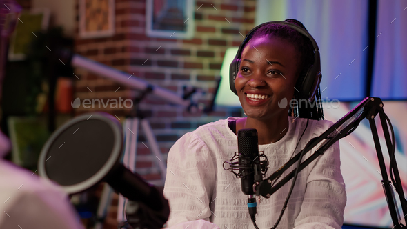 Closeup of african american podcaster in home recording studio in ...