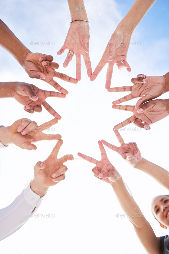 Shot of a group of unrecognizable people making a star shape with their ...