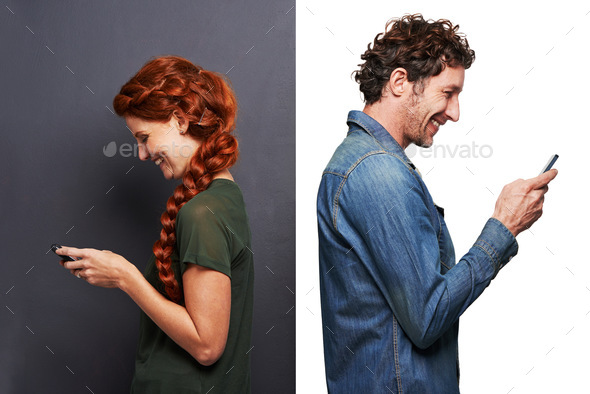 Shot of two young people text messaging each other while standing on ...