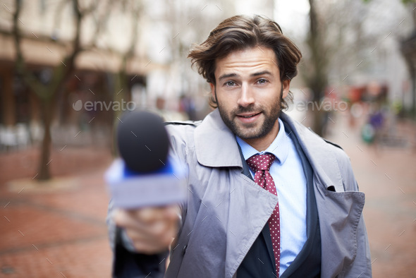 Care to comment. Cropped portrait of a handsome news reporter doing an ...