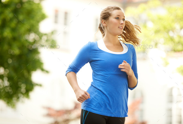 Taking a run. Attractive young woman out for a run. Stock Photo by ...