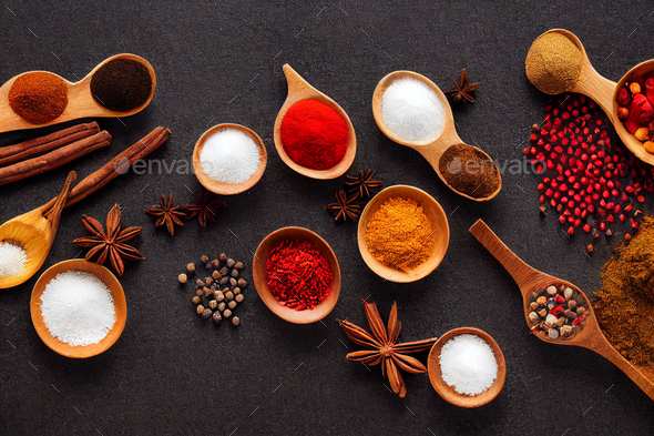 Rack with traditional indian spices for cooking - cardamom, turmeric ...