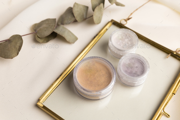 Top view eye shadow and facial powder on natural background with dried ...