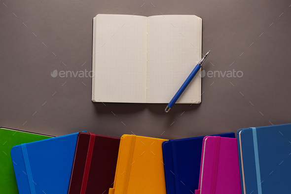 Open notepad and notebook heap on paper table background. Back to ...