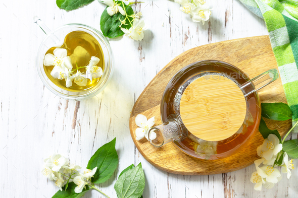 Therapeutic herbal tea. Hot Jasmine tea with jasmine flowers in a glass ...