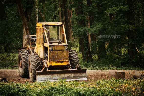 Old tractor on the forest deforestation work Stock Photo by linux87