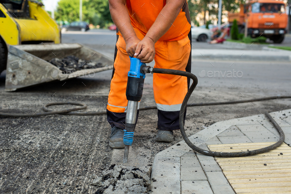 Road worker breaking street asphalt with jackhammer. Stock Photo by ...
