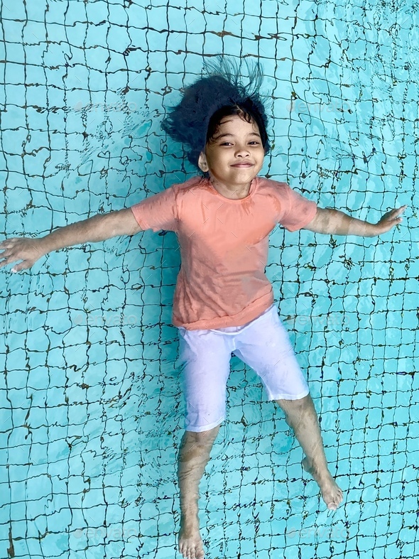 Little girl floating in the swimming pool Stock Photo by lolodean ...