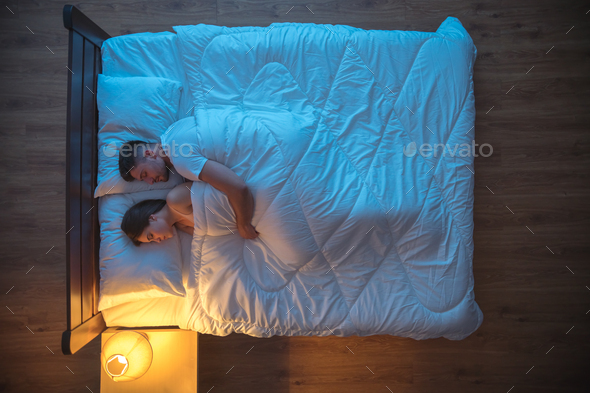 The man hug a woman on the bed. night time. view from above. Stock ...