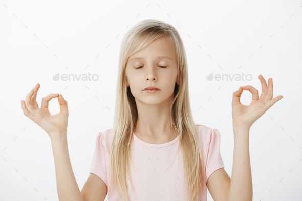 Focused calm european girl trying meditation with mom. Portrait of ...