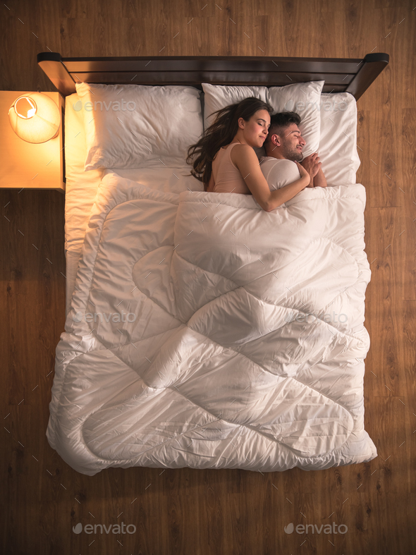 The woman hug a man on the bed. view from above. Stock Photo by artemp3