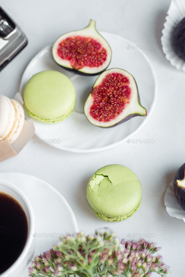 aesthetic layout of figs and macarons on a white background, top view ...