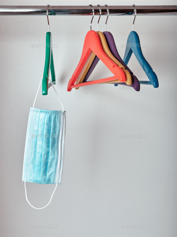 Face mask hangs in wardrobe on hanger along with other empty hangers ...