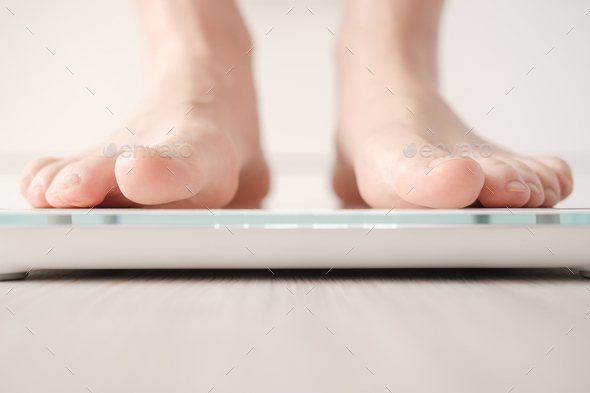 Bare feet stand on smart scales makes bioelectric impedance analysis ...