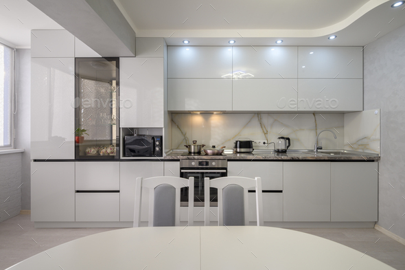 Interior of modern trendy white kitchen, front view Stock Photo by staRRush