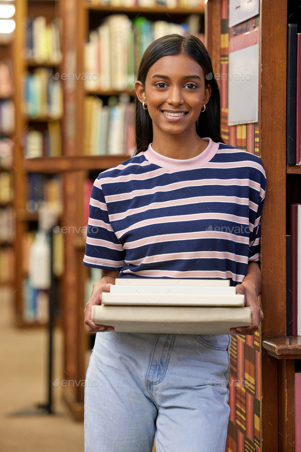 Nothing is pleasanter than exploring a library. Shot of a young woman ...