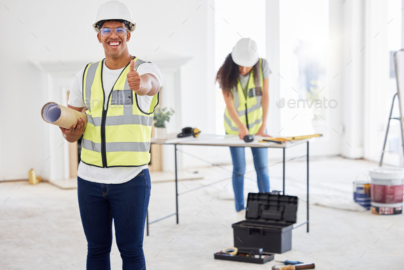 Shot of a handsome young contractor standing inside and showing a ...