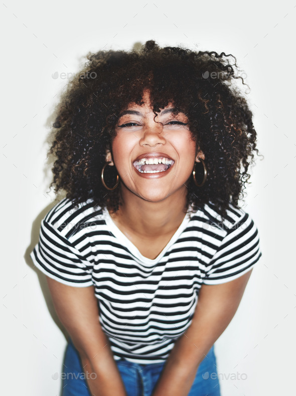 Bursting with happiness. Studio shot of a happy young woman posing ...