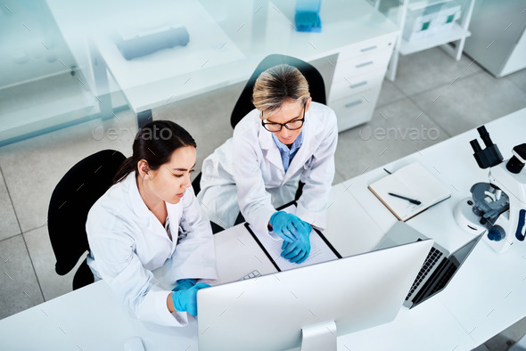 Shot of two scientists working together on a computer in a lab Stock Photo by YuriArcursPeopleimages