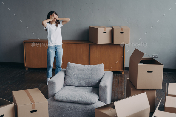 Tired woman surrounded by carton boxes feels stress of relocation ...
