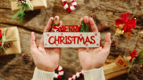Hand Holding Merry Christmas text on presents background Stock Photo by ...